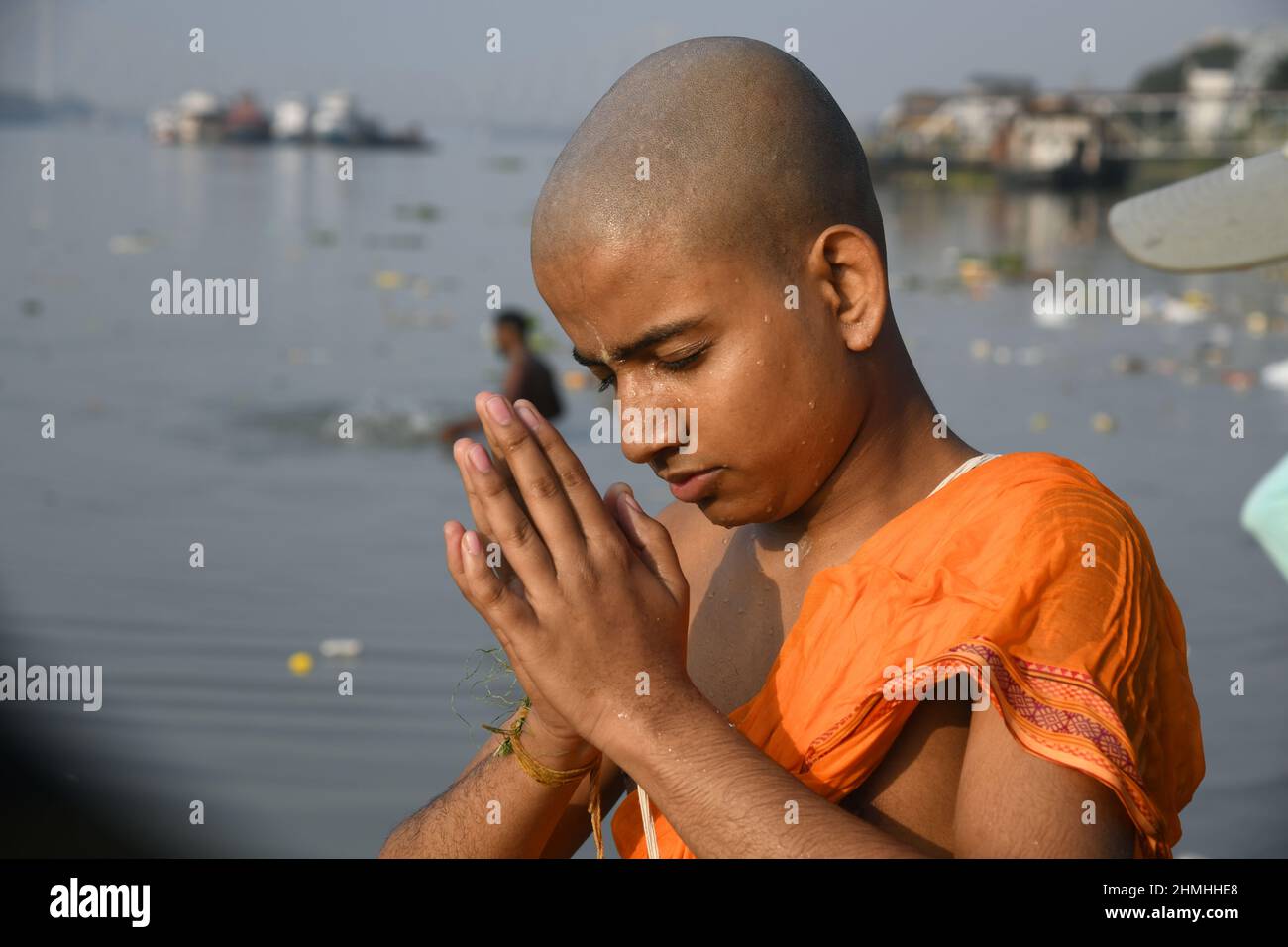 A Hindu Brahmin boy performing pranam after dip in the Ganges at the ...
