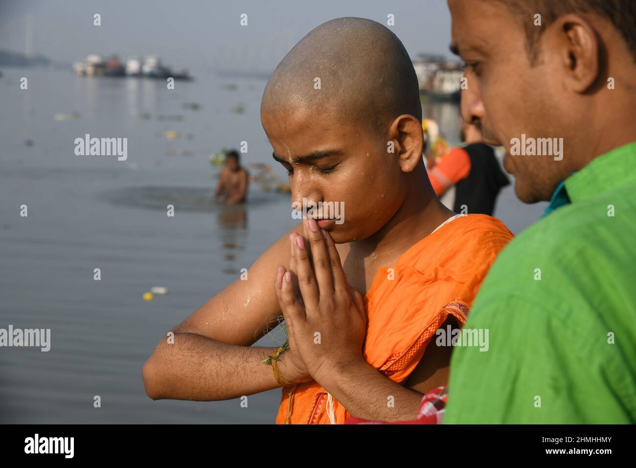 A Hindu Brahmin boy performing pranam after dip in the Ganges at the ...