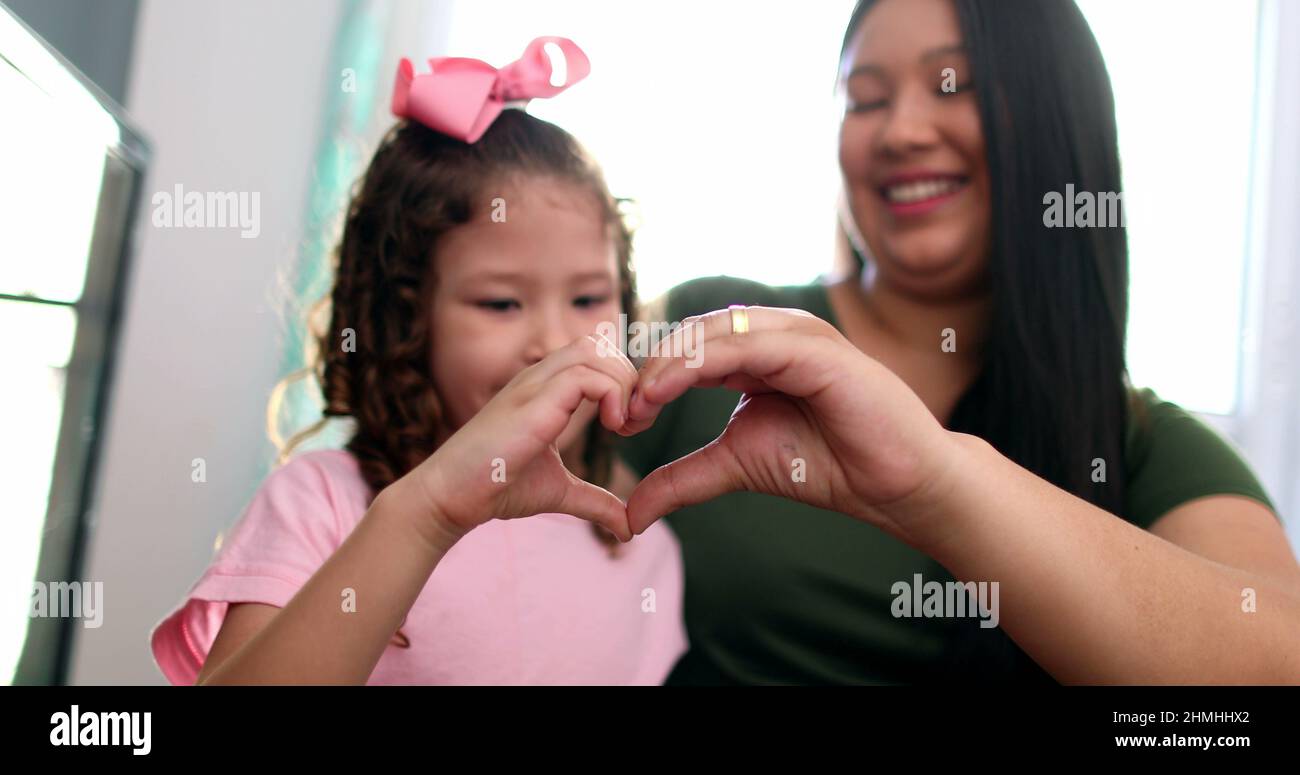 Mother and child doing heart symbol sign with hands Stock Photo - Alamy