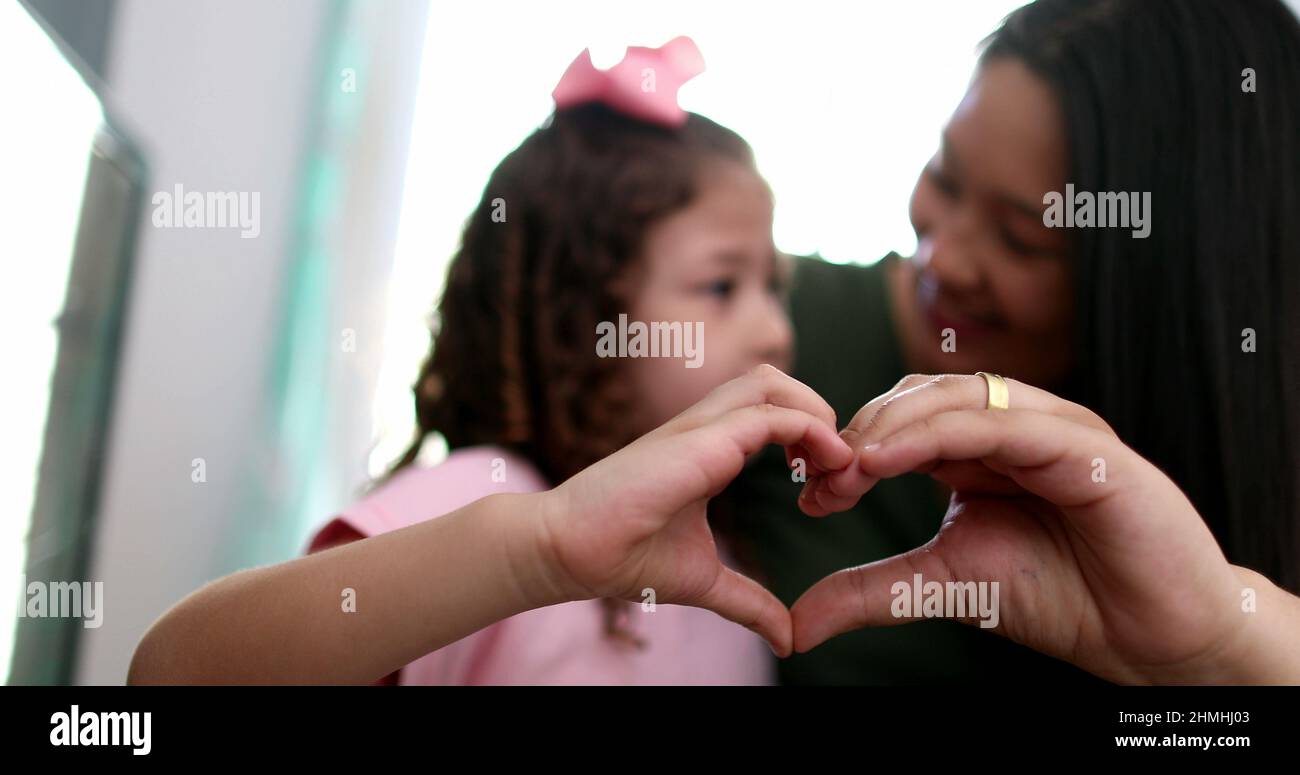 Mother and child doing heart symbol sign with hands Stock Photo - Alamy