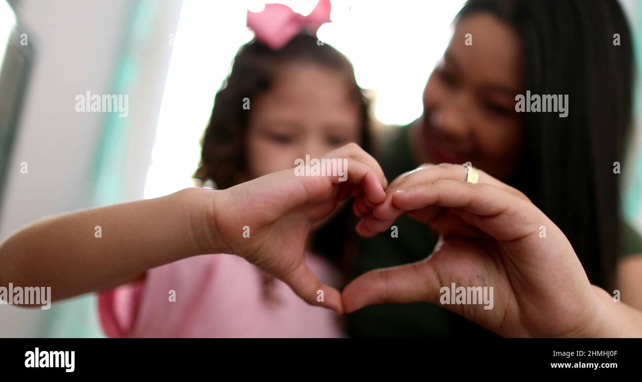 Mother and child doing heart symbol sign with hands Stock Photo - Alamy