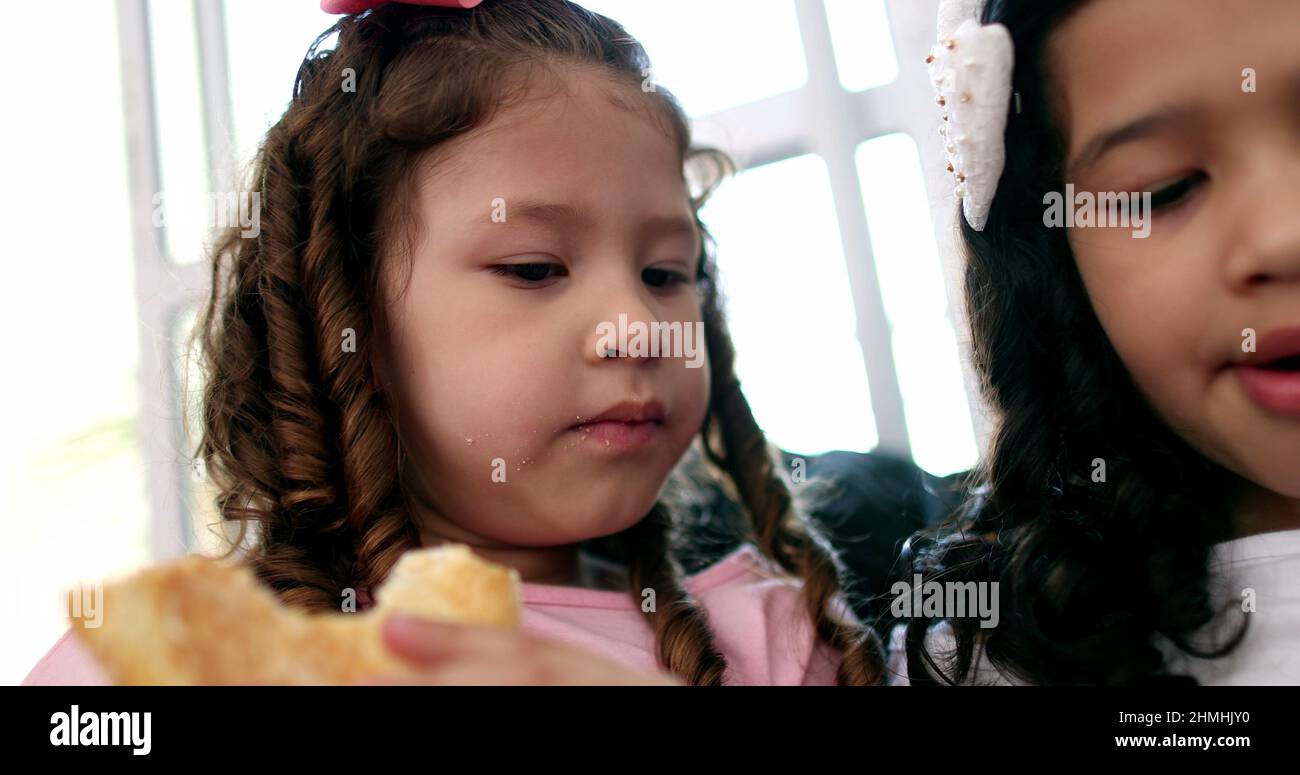Two little girls eating sandwiches, children afternoon snack Stock ...