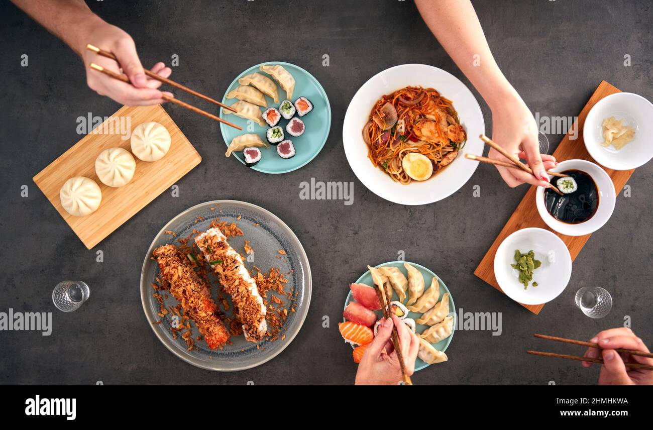 Overhead View Of Friends In Chinese Restaurant Eating Meal Together ...