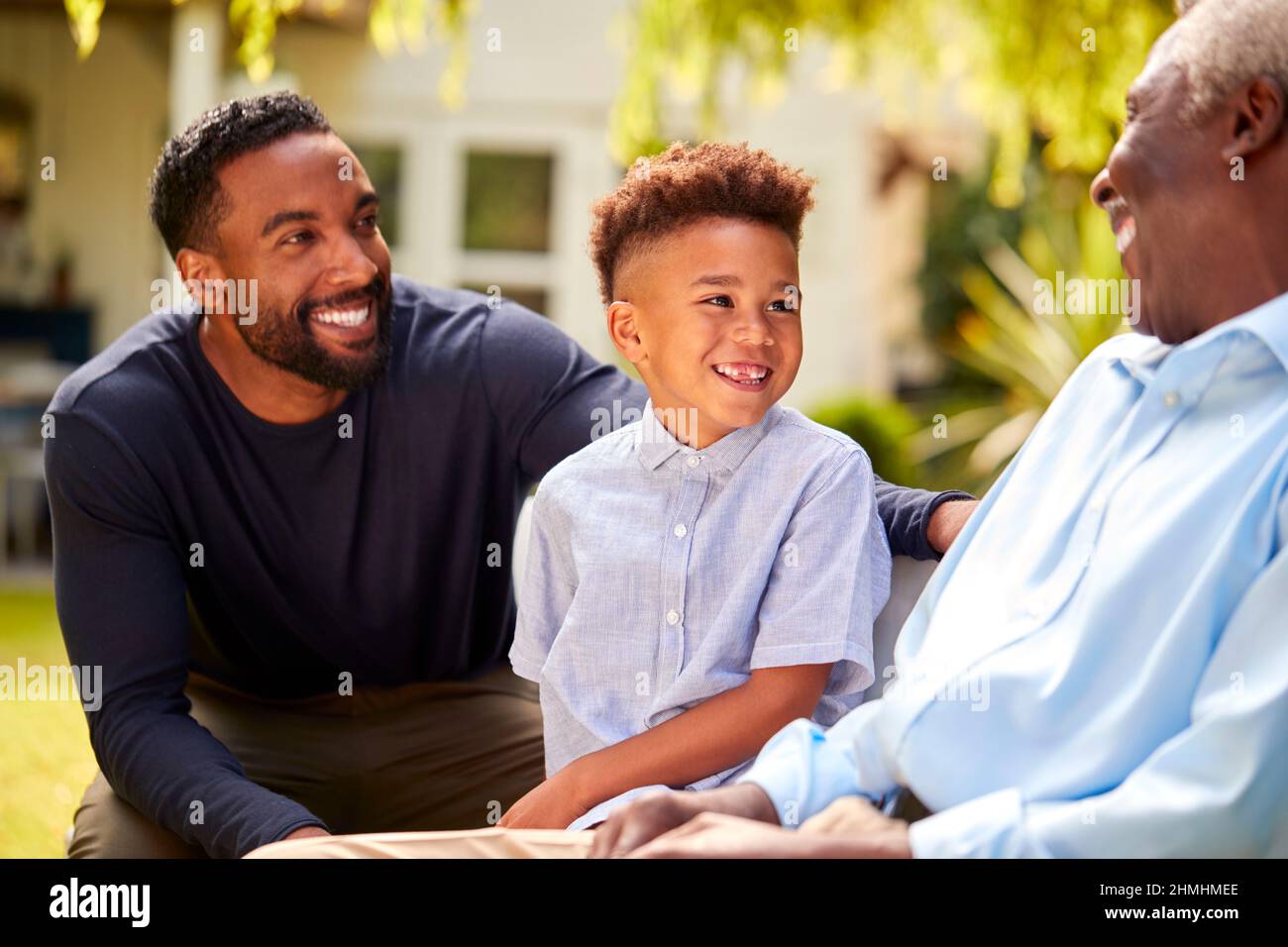 Smiling Multi-Generation Male Family At Home In Garden Together Stock ...