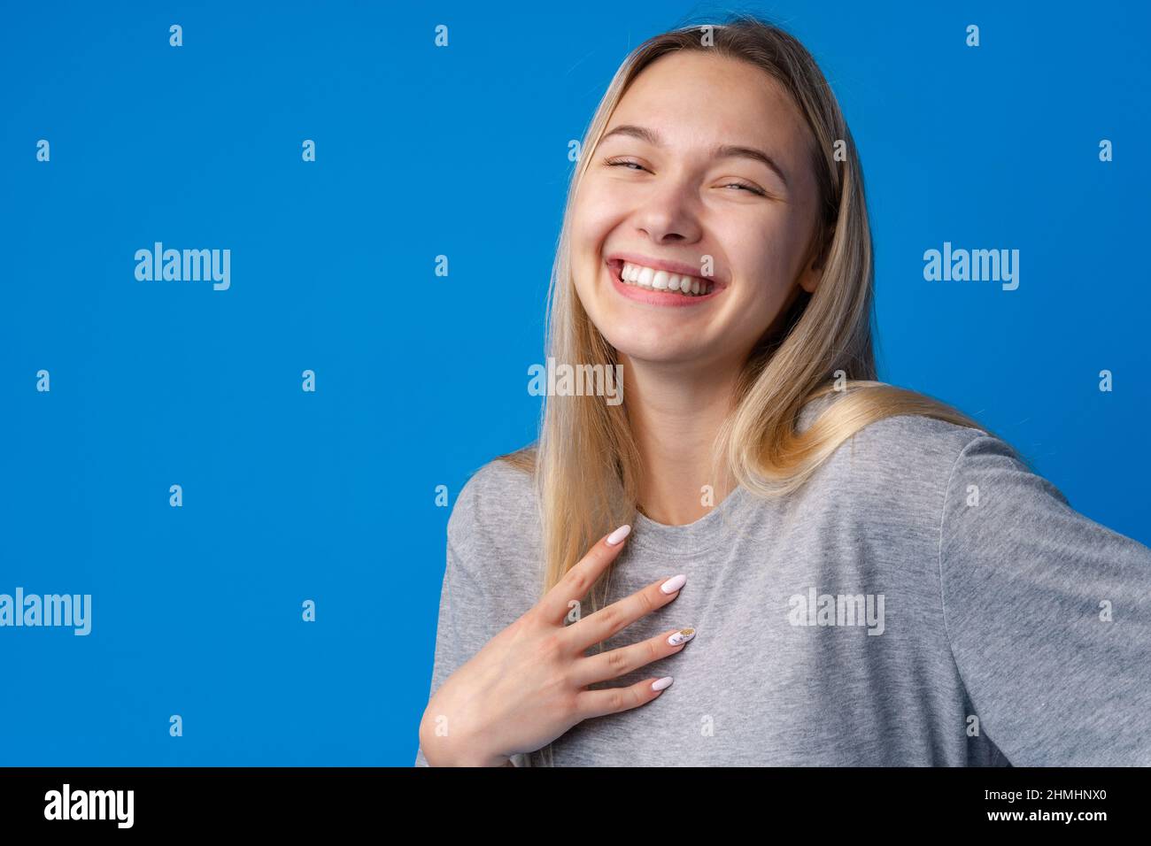 Happy smiling pretty teenage girl laughing over blue background Stock ...