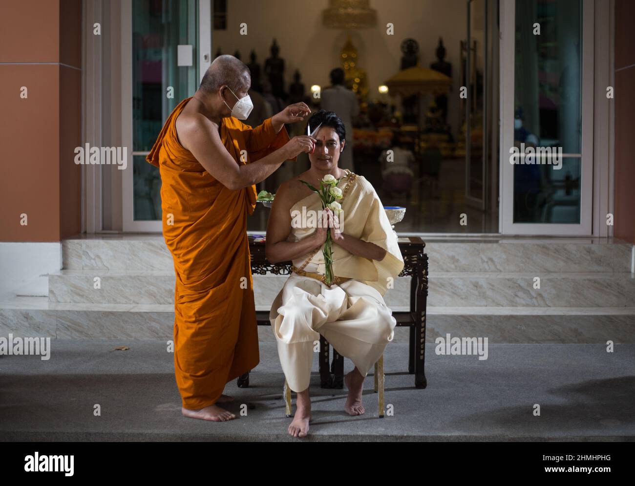 A monk shaves the head of Indian actor Gagan Malik before the Buddhist ...