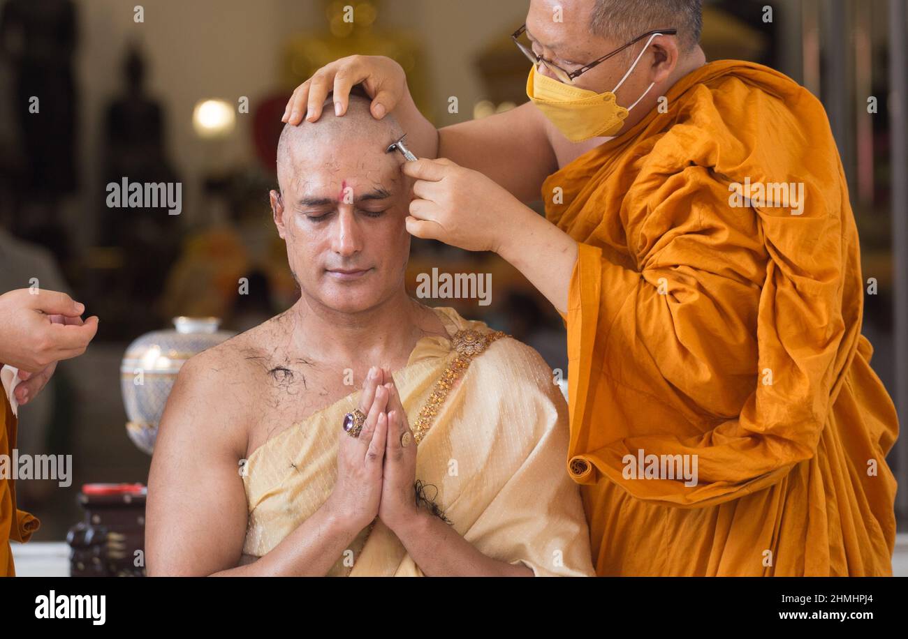 A monk shaves the head of Indian actor Gagan Malik before the Buddhist ...