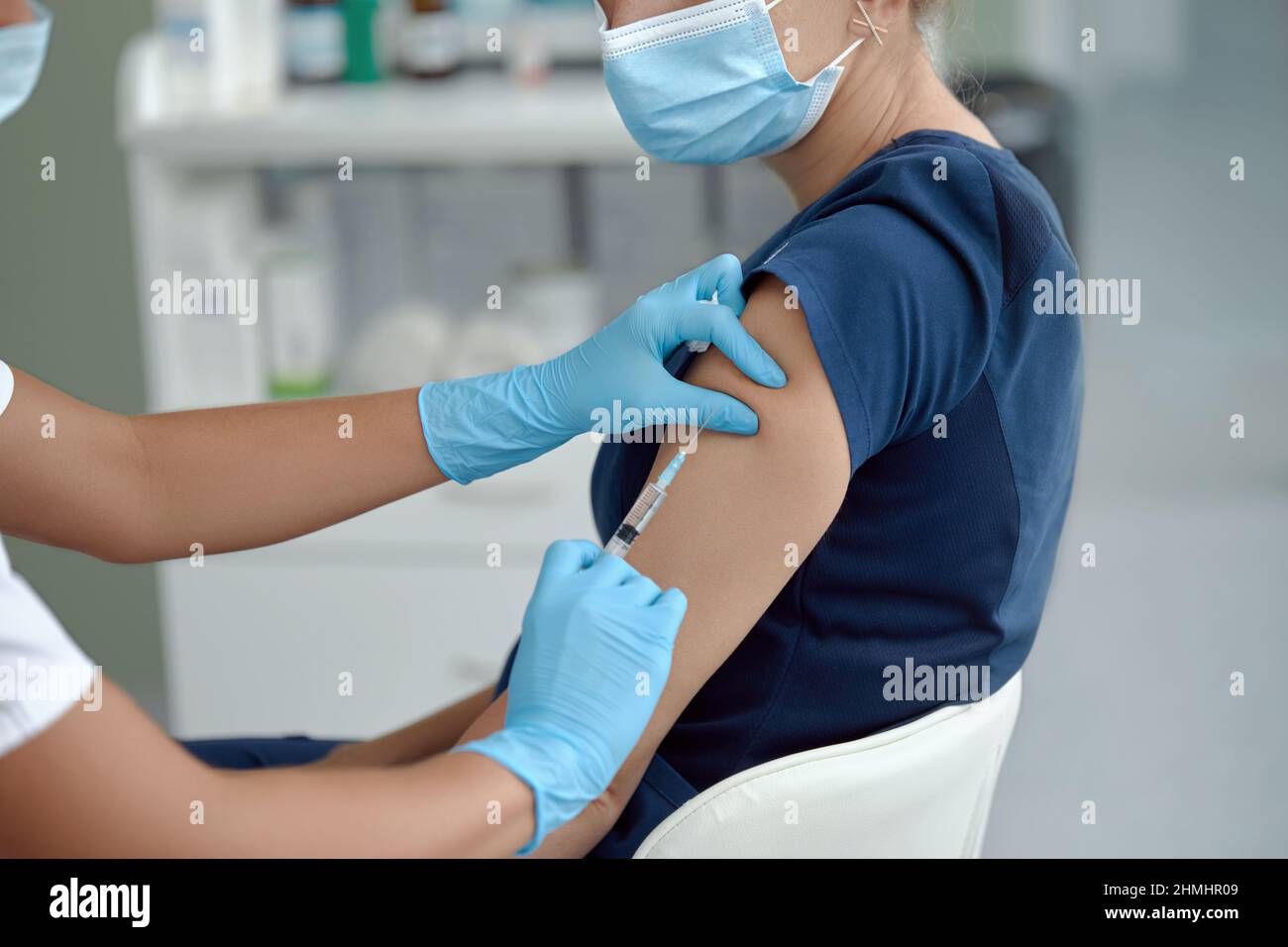 woman doctor holding syringe making covid 19 vaccination injection dose ...
