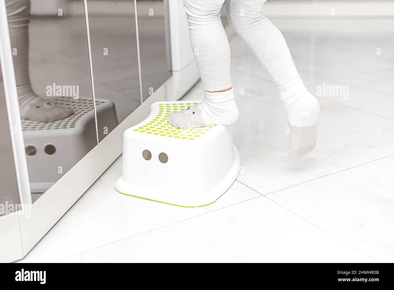 Small feet stand on a stand for children Stock Photo - Alamy