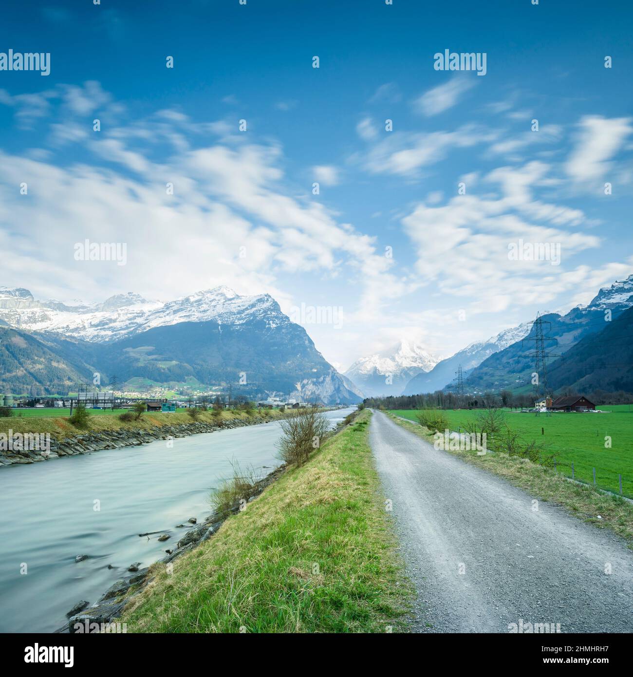 Alpine landscape. The road and the river flows side by side. Long ...