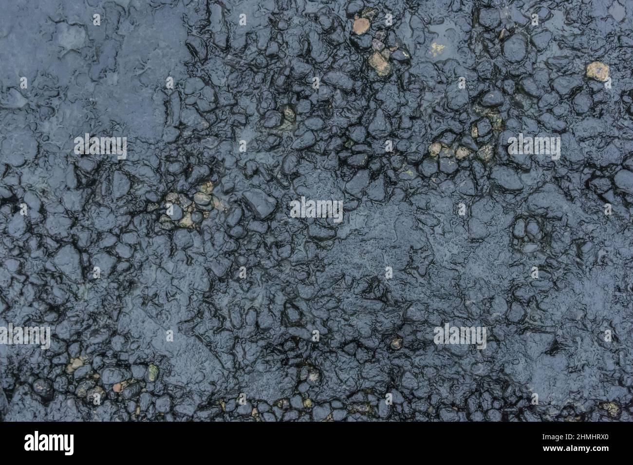 Fuel pollution soil dirt oil blue rough stone surface of the earth ...