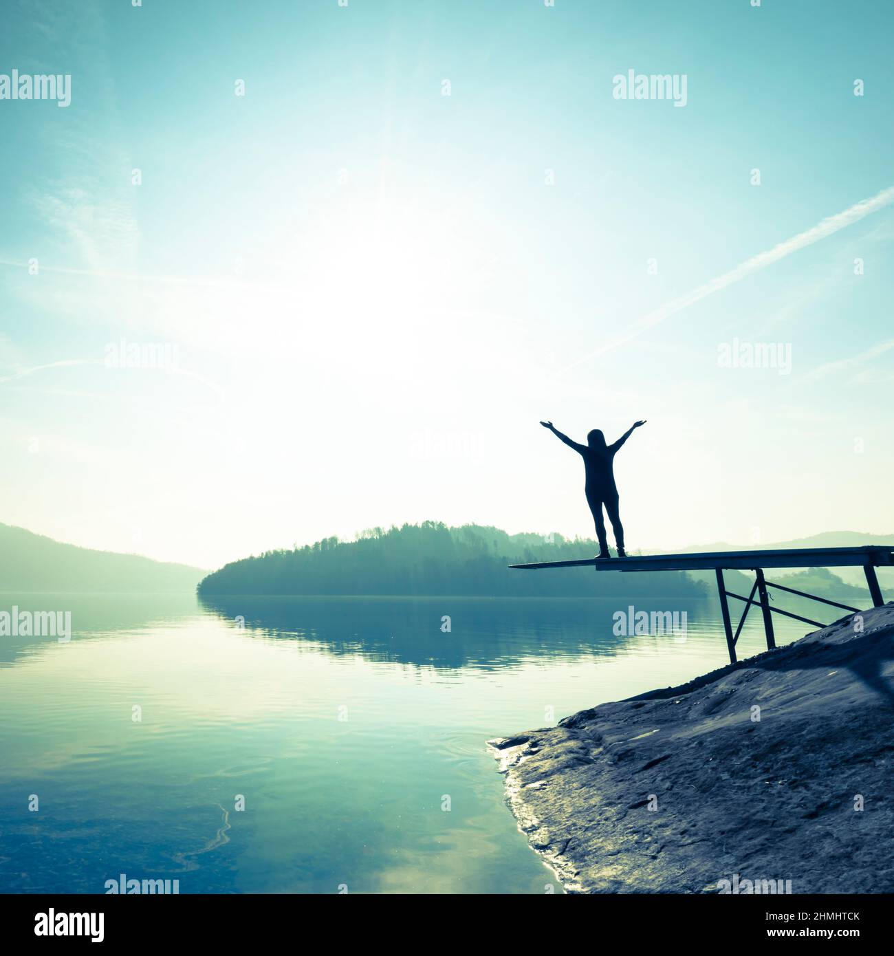 Landscape on the lake. Bright sun on a clear day. Figure of a woman ...