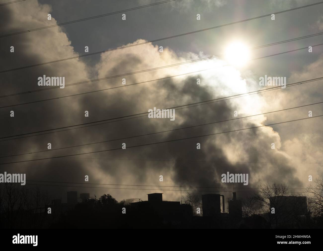 Fumes and pollution in factory chimneys Stock Photo - Alamy