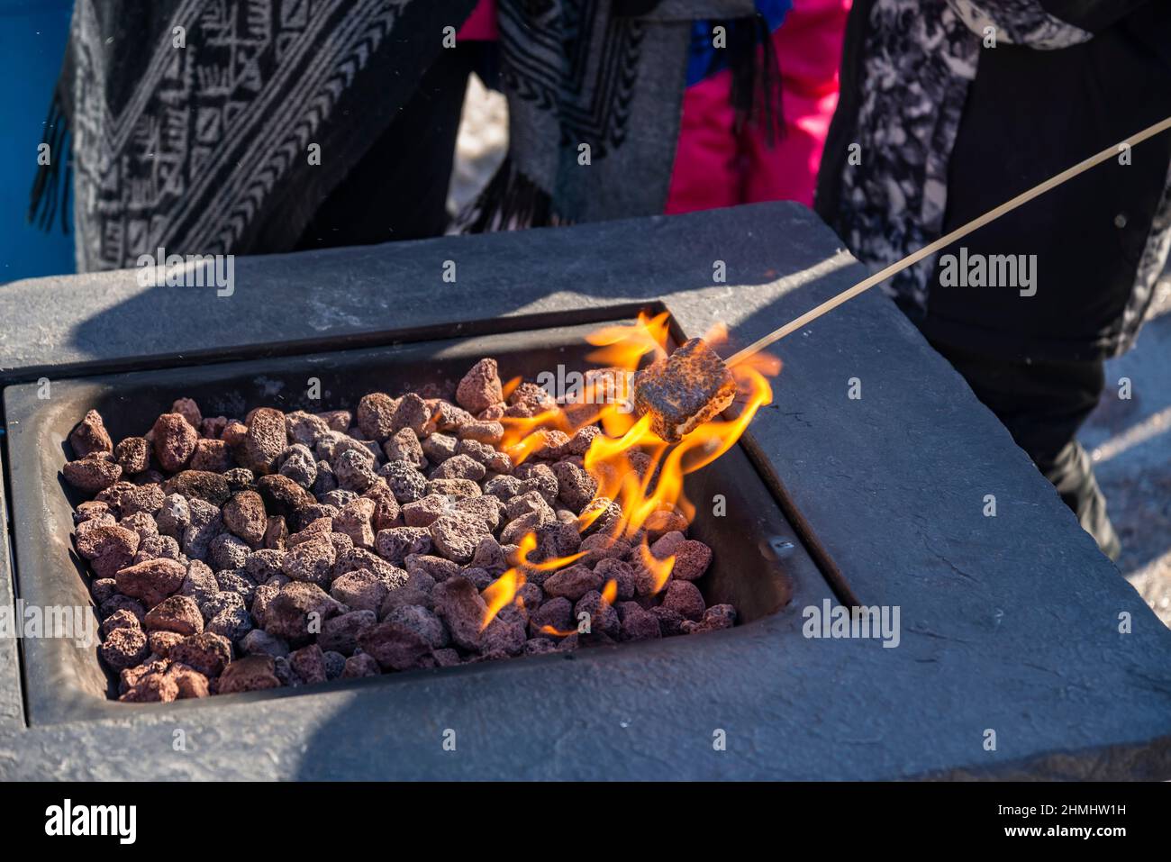 A marshmallow on a stick being roasted over a camping fire Stock Photo ...