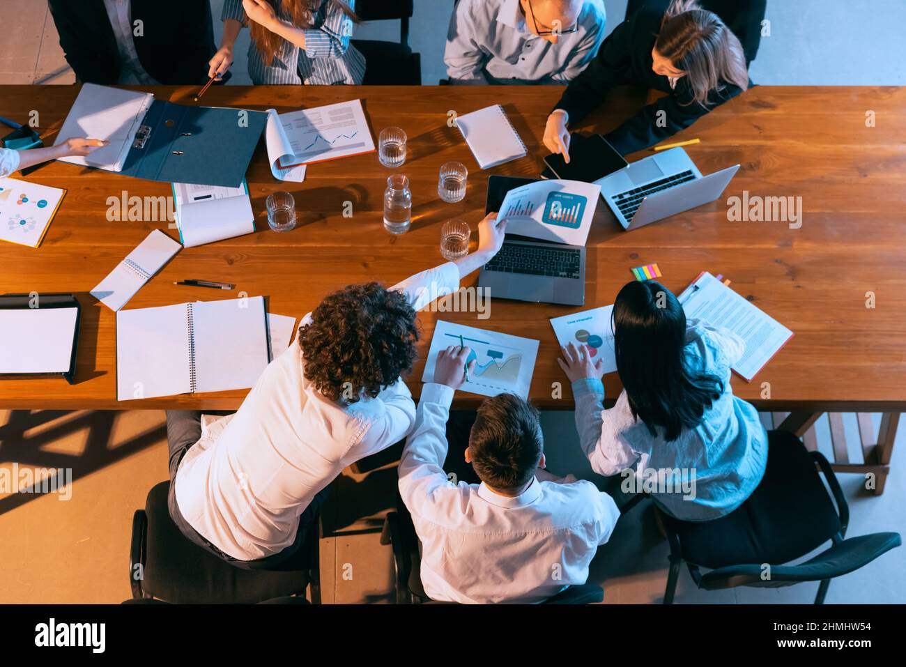 Young, motivated men and women, businessmen talking, working with ...