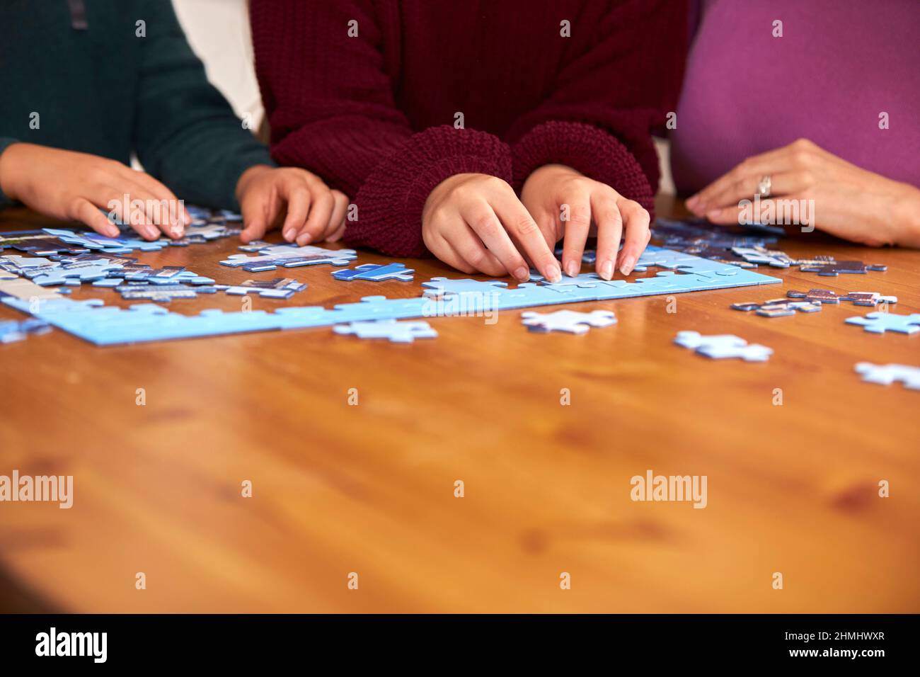 Children doing puzzle at table hi-res stock photography and images - Alamy