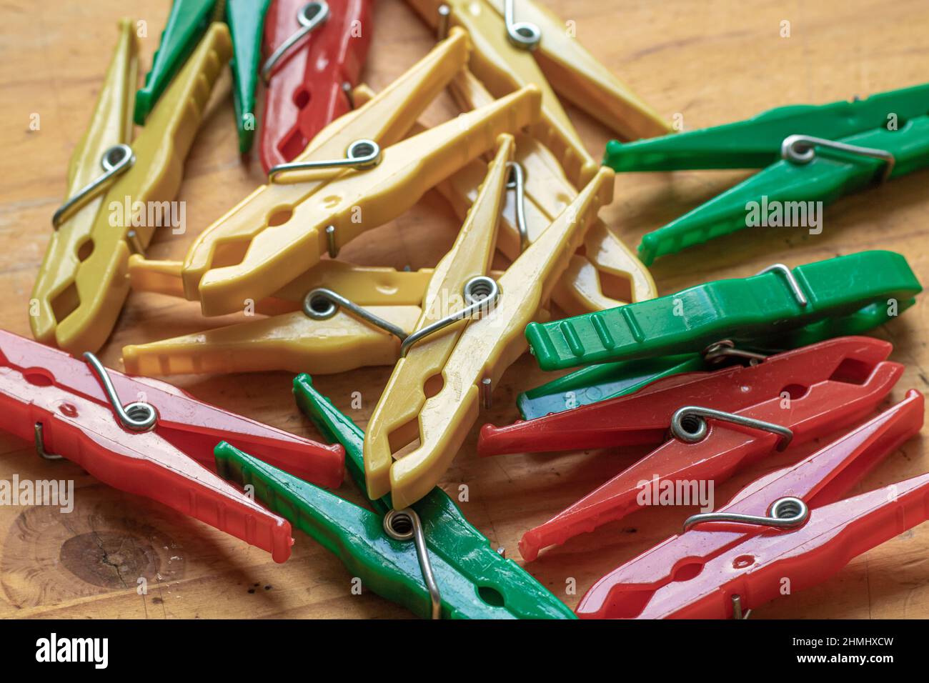 Different classic clothespins made of plastic from a surface with old ...