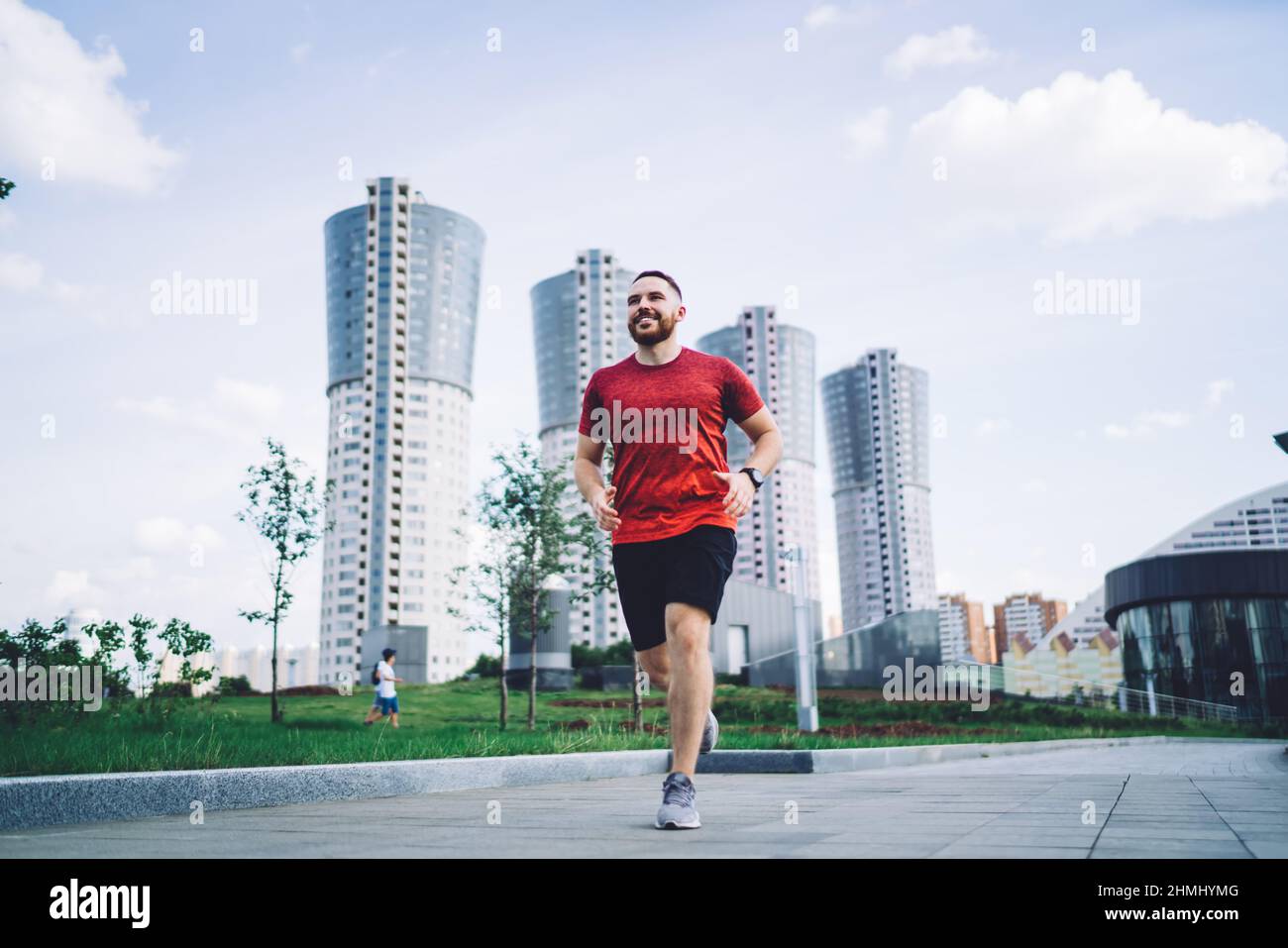 Young sportsman running on sidewalk in downtown Stock Photo - Alamy