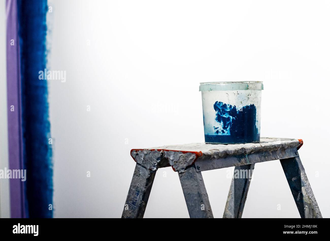 Construction grunge ladder, paint roller and paint bucket in white ...