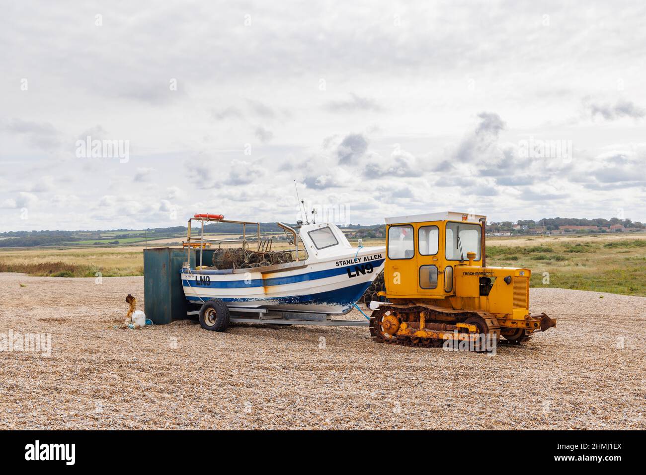 Fishing boat on a trailer pulled by a tracked crawler dozer on a ...