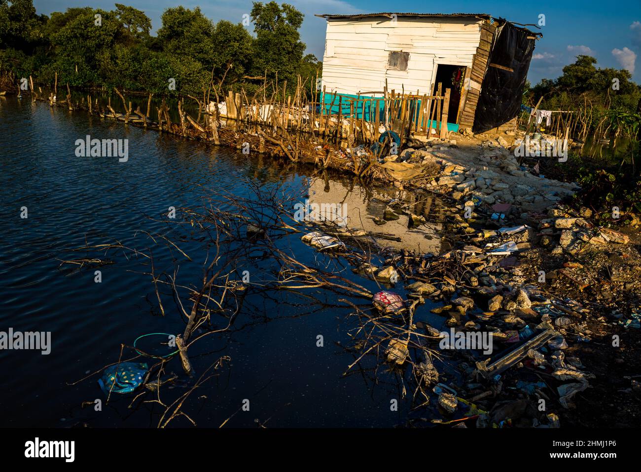 A house made of recycled materials is seen built on the shore of a ...
