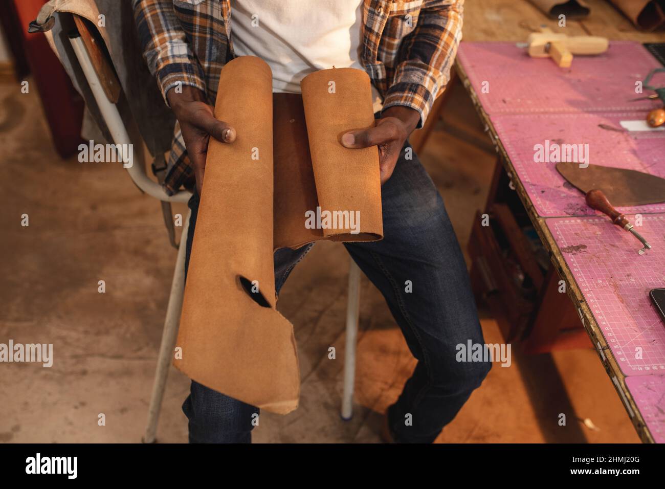 African american craftsman working leather hi-res stock photography and ...
