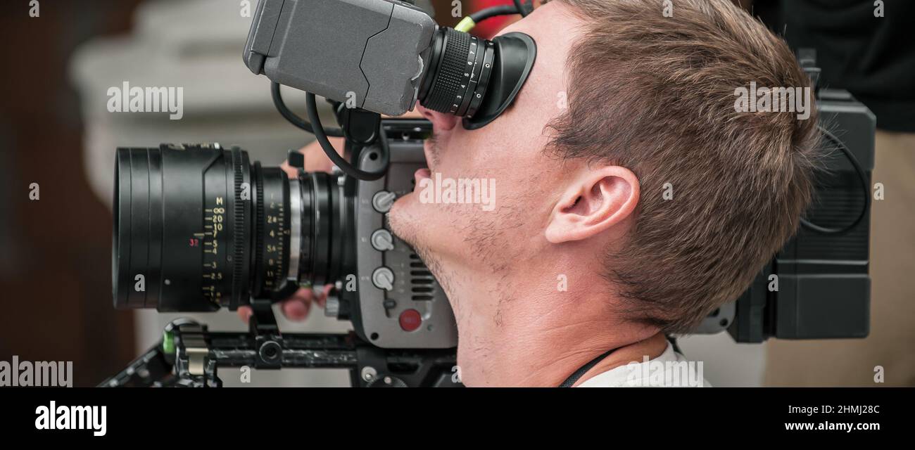 Behind the scene. Cameraman shooting the film scene with his camera on ...