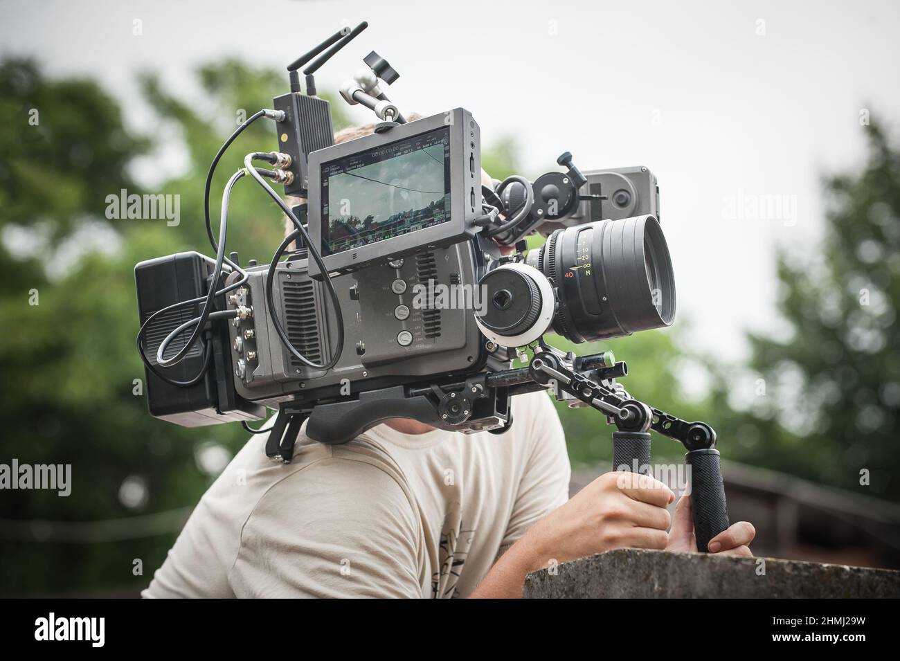 Behind the scene. Cameraman shooting the film scene with his camera on ...