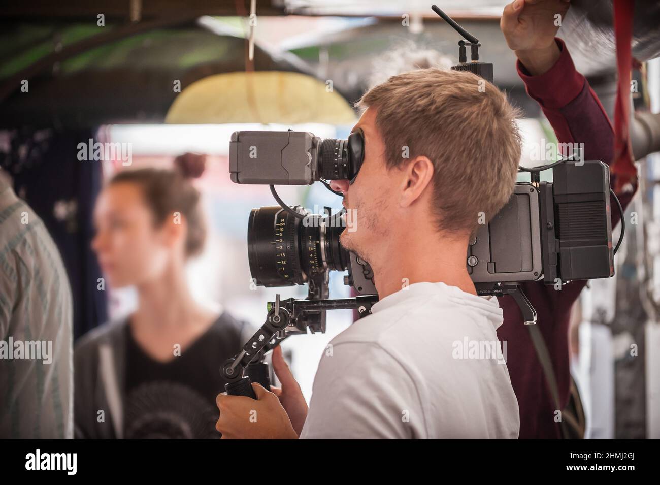 Behind the scene. Cameraman shooting the film scene with his camera on ...