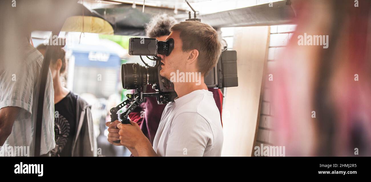 Behind the scene. Cameraman shooting the film scene with his camera on ...
