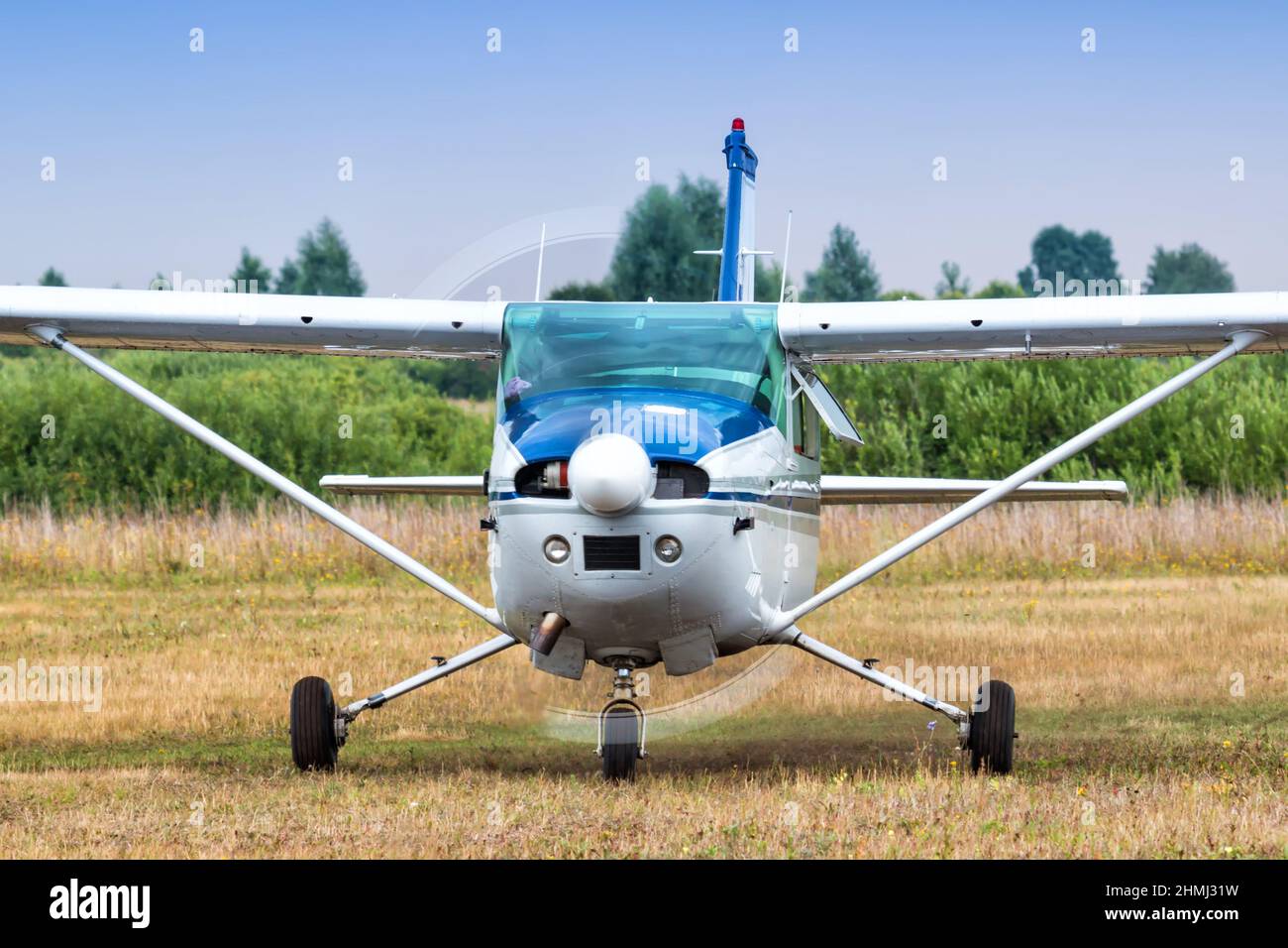 Front view of the small private aircraft with the engine running at the ...