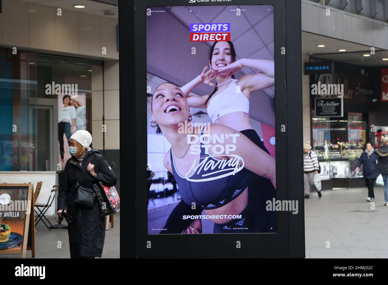 London, UK. 10th Feb, 2022. A woman walks past a 'Sports Direct ...