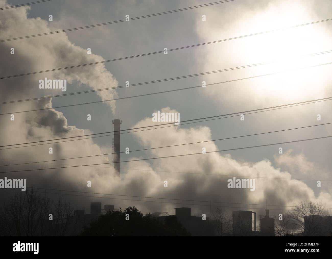 Fumes and pollution in factory chimneys Stock Photo - Alamy