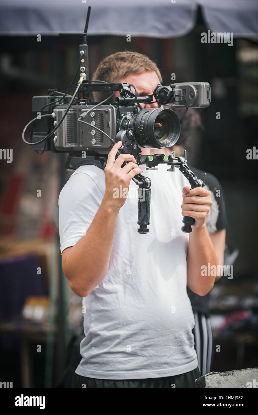 Behind the scene. Cameraman shooting the film scene with his camera on ...