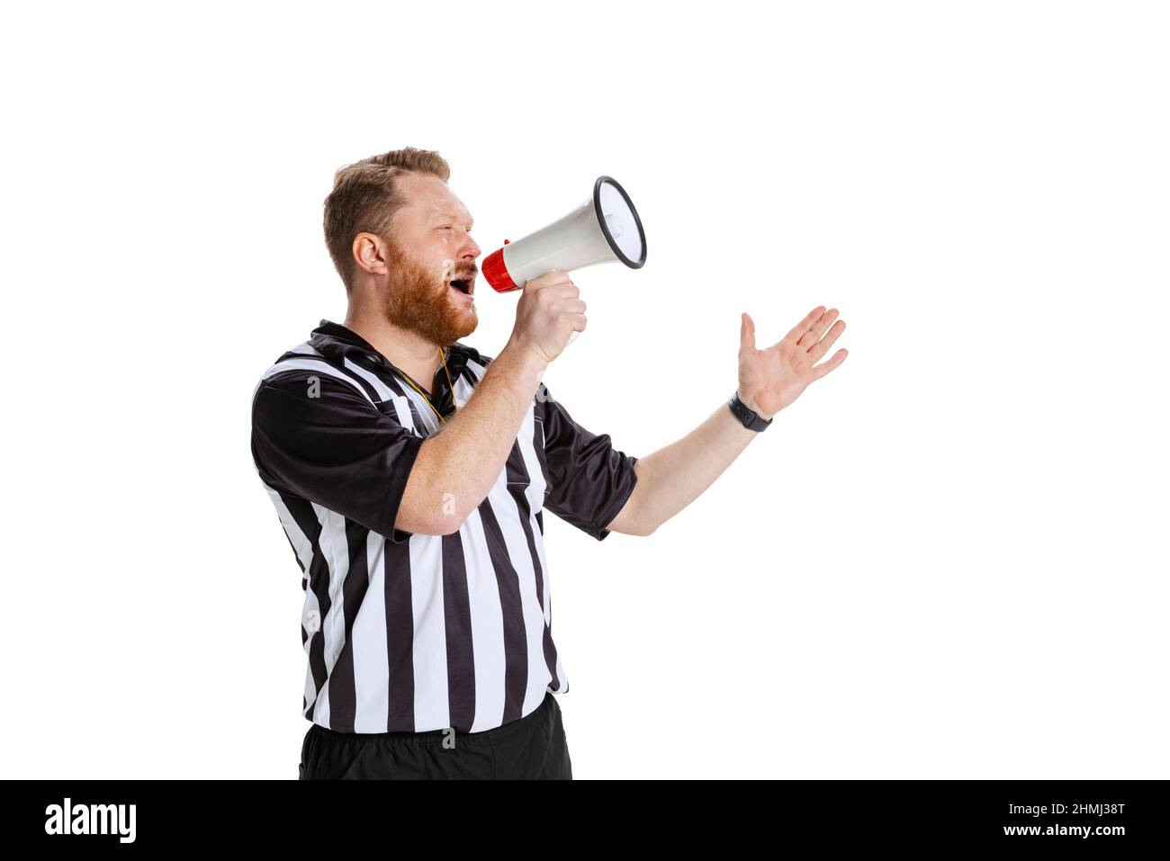 One young bearded man, soccer or football referee shouting at megaphone ...