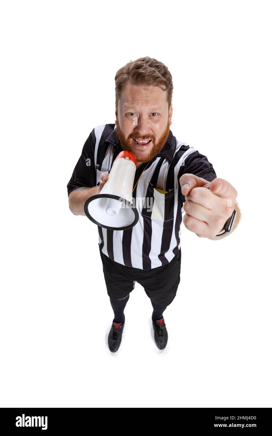 One young bearded man, soccer or football referee shouting at megaphone ...