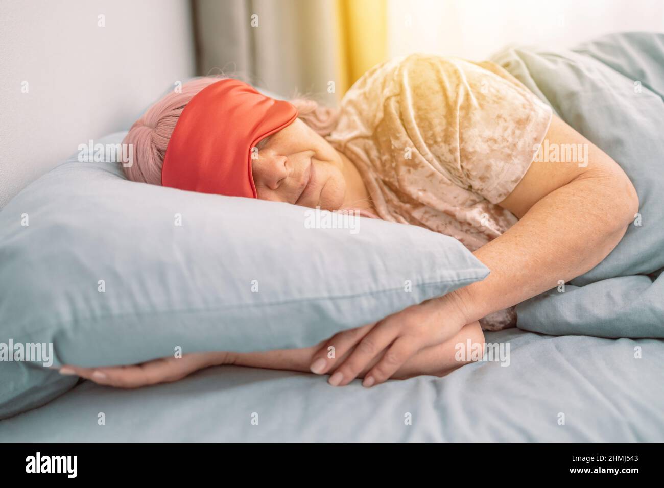 Woman in red sleep mask sleeping in bed Stock Photo - Alamy