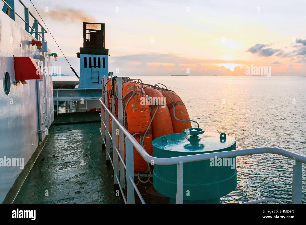 Orange inflatable lifeboats on ferry deck for emergencies and maritime ...
