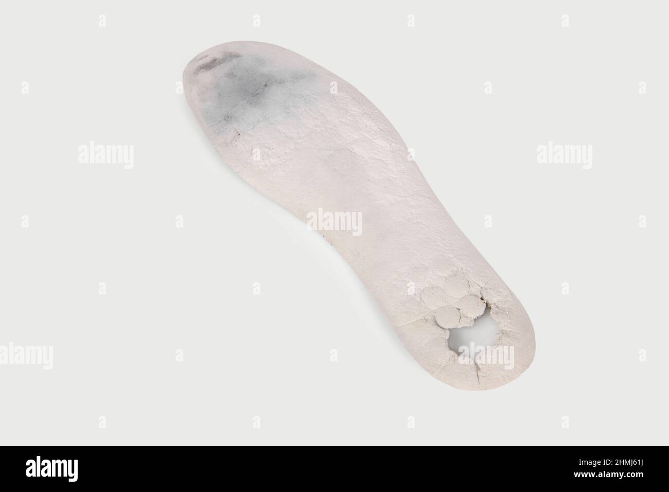 Old and shabby orthopedic insoles isolated on white background. Dirty ...
