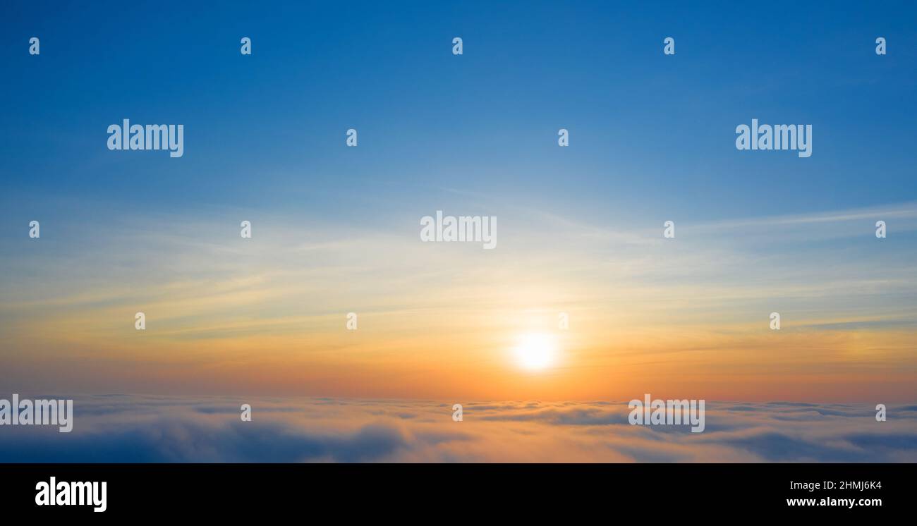 Above the clouds, sunrise or sunset. Clear sky over the fog. View from ...