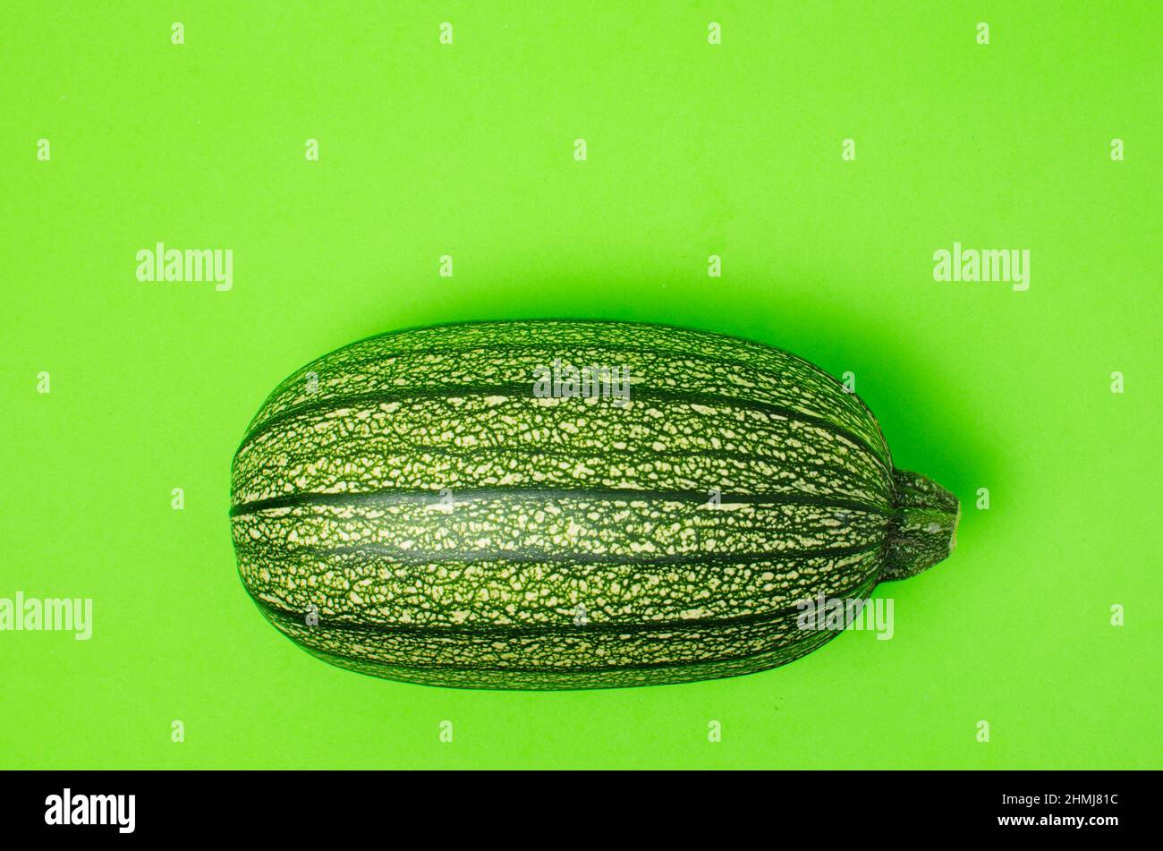 Zucchini on a green background, healthy green vegetables. Close up ...