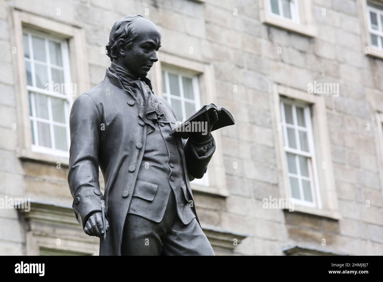 A statue of Oliver Goldsmith at Trinity College Stock Photo - Alamy