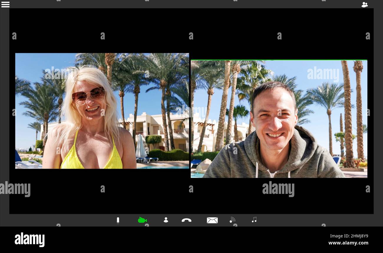 woman on the street among the palm trees talking by video link. Sunny ...