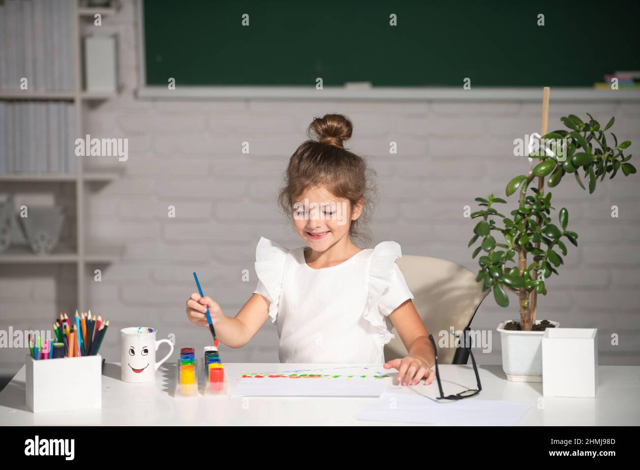 Child girl drawing with coloring pens paintind. Portrait of adorable ...