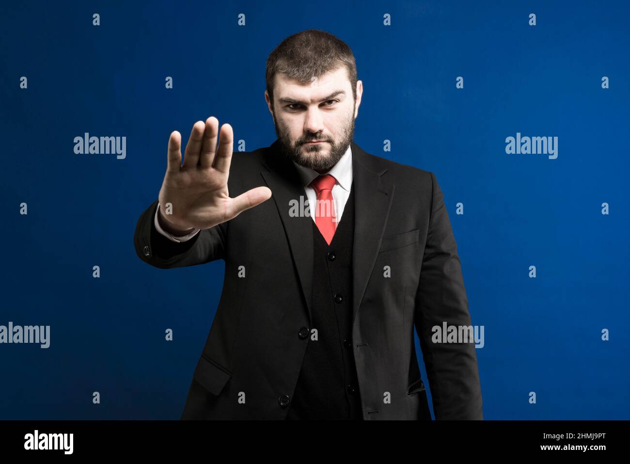 The man in the suit put his palm forward. Stop hand sign. Hand gesture ...