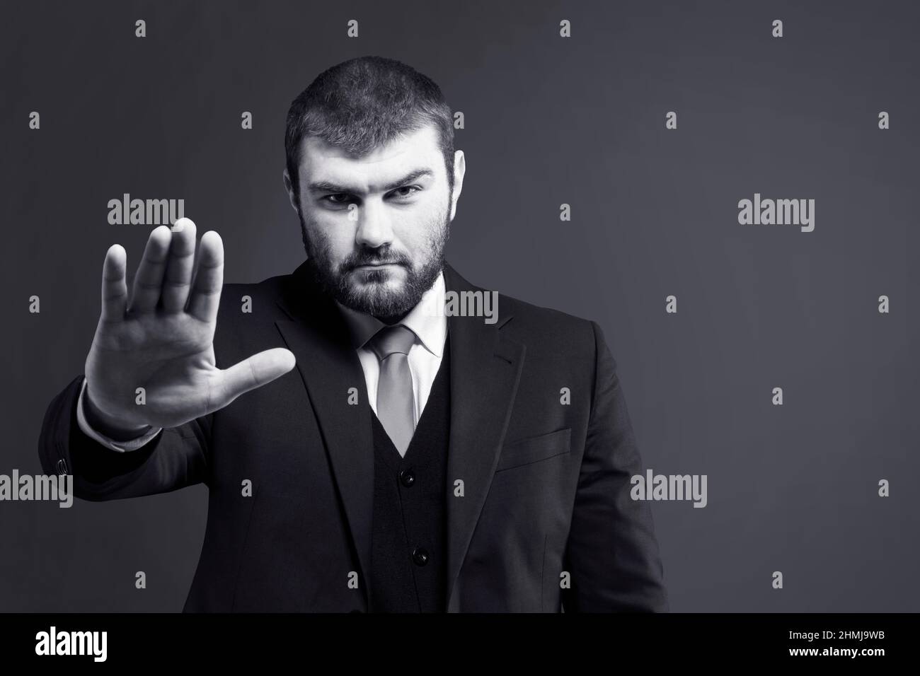 Stop. Stop hand sign. The man in the suit put his palm forward. Stop ...