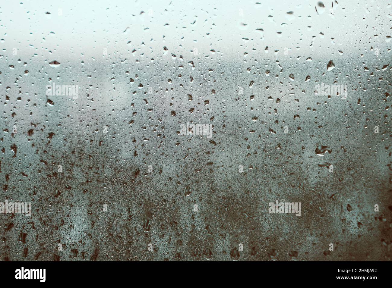 Fogged, wet glass with raindrops in the movie style. Background ...