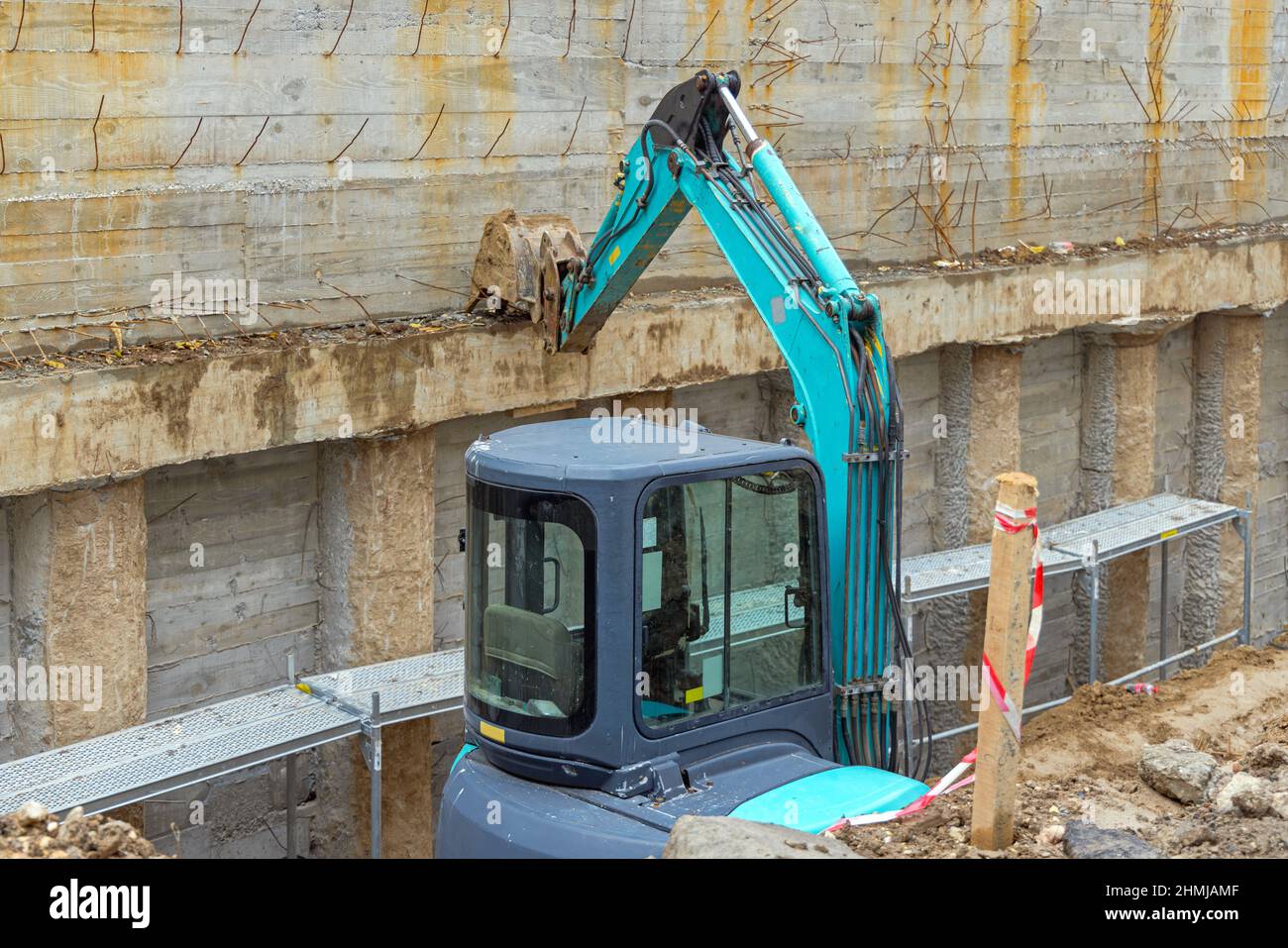 Small Digger Machine in Underground Basement Concrete Construction Site ...