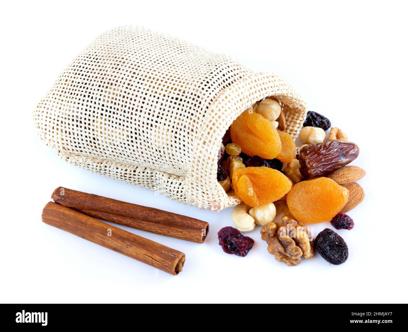 Dried fruits and nuts in a sack on white background Stock Photo - Alamy