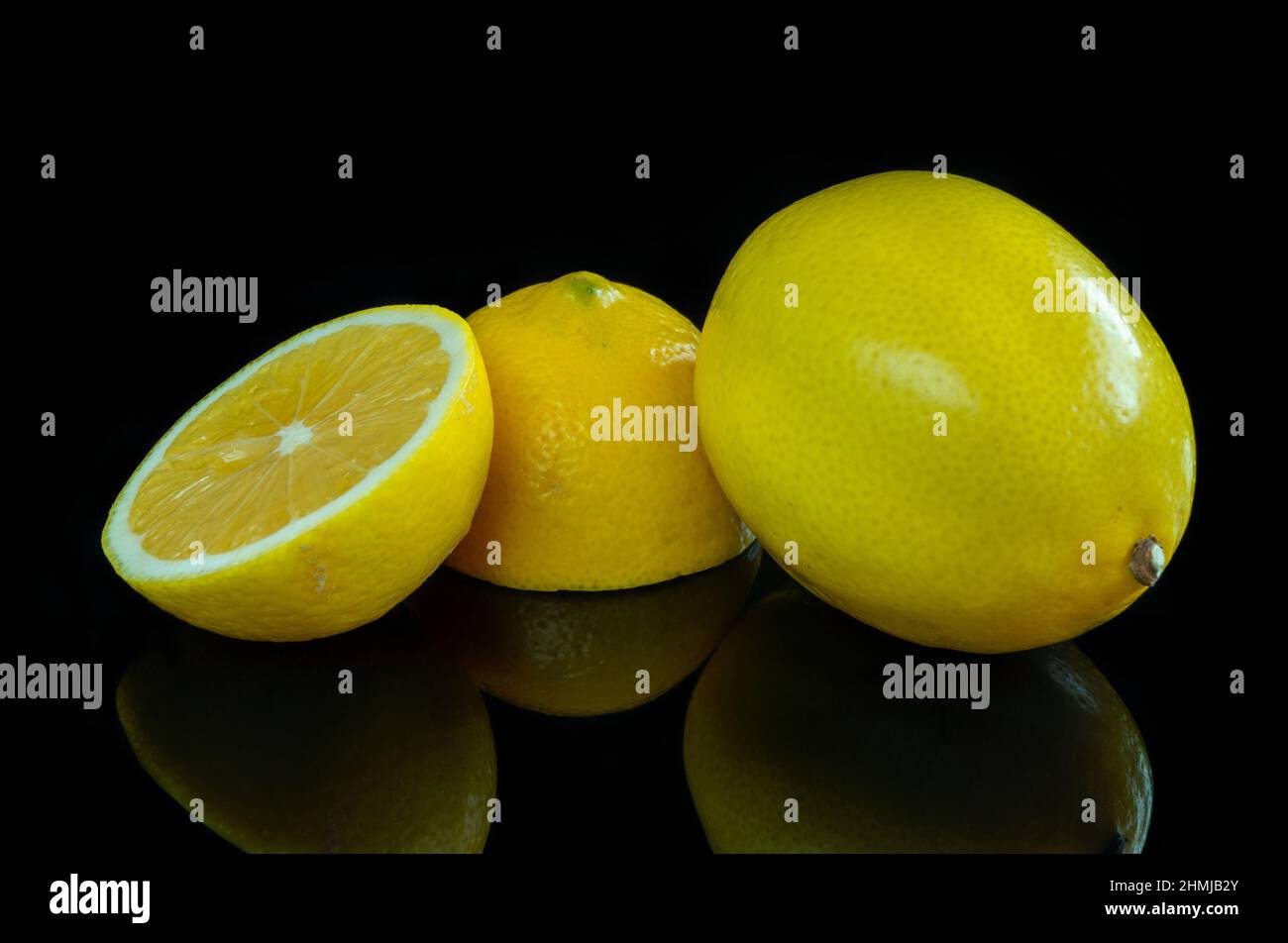 Lemons on reflective black studio background Stock Photo - Alamy